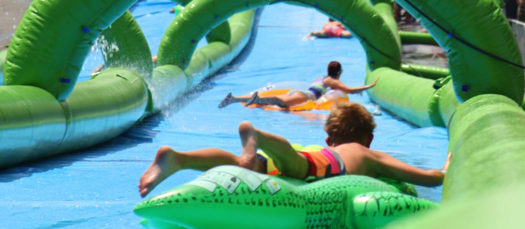Slide the City is Bringing a Water Park Block Party to Newark!